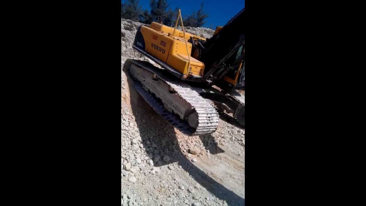 Excavator sliding down a slope - YouTube