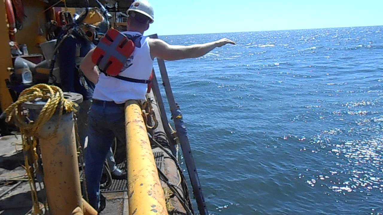 Commercial diver does a sailor dive entering the water. - YouTube