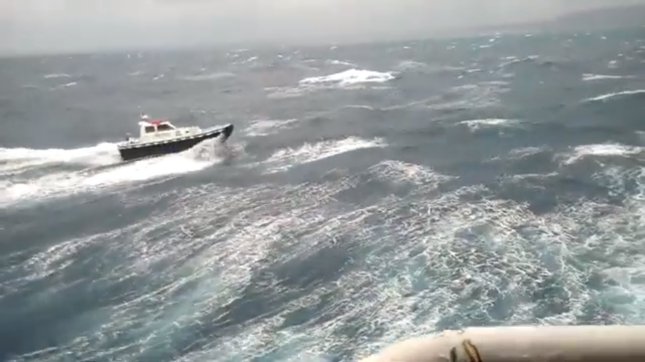 A marine pilot embarking a ship in Cape Town's rough seas - YouTube