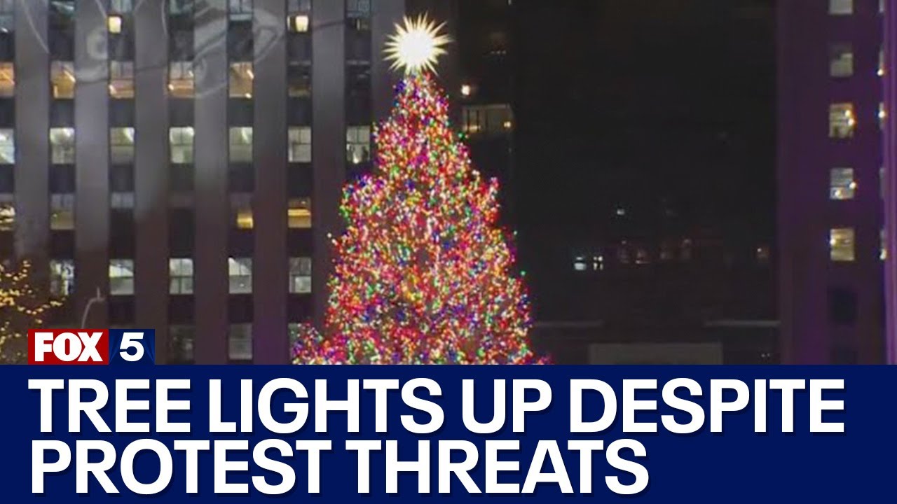 Rockefeller Christmas Tree lights up despite protest threats - YouTube