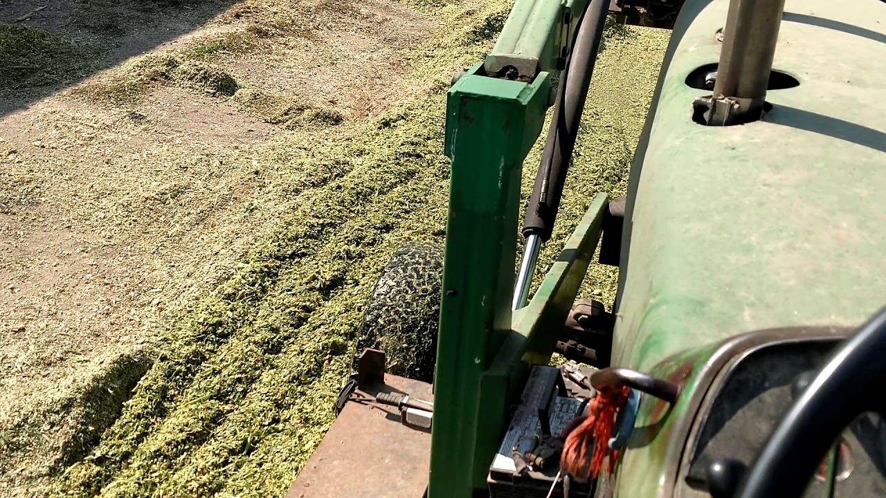 Packing silage between loads - YouTube