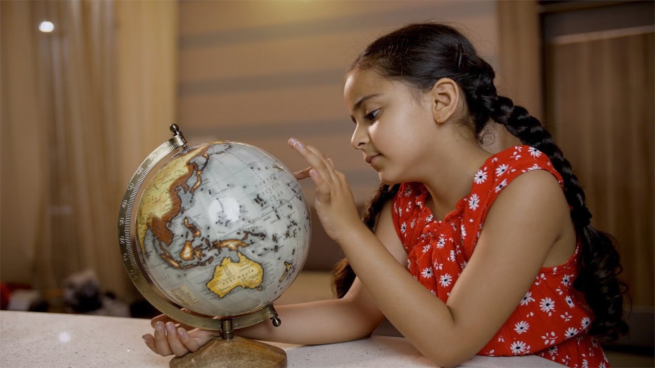 Thoughtful little Indian child preschooler looking and playing ...