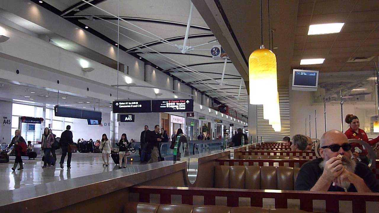 Silent train running inside the Detroit airport terminal building - YouTube