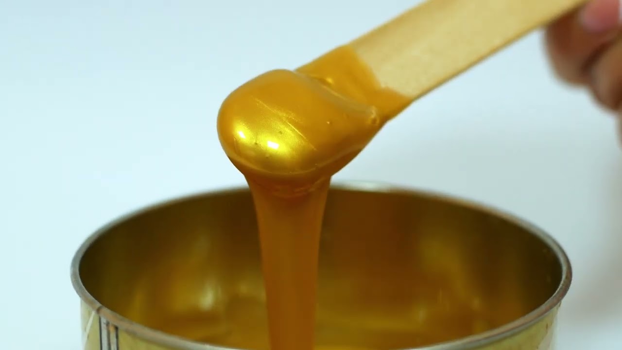 Gold depilatory wax drips from the wooden skewer Free Stocks video, No ...