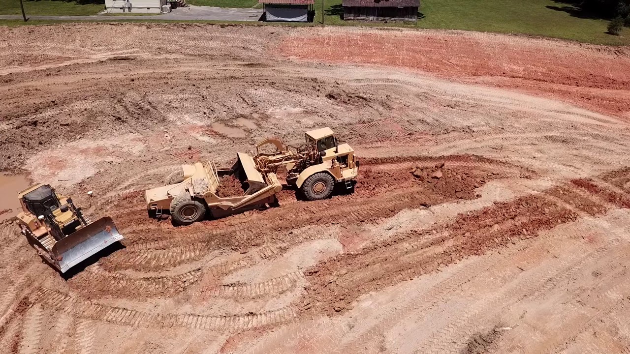 Scraper and dozer working - YouTube