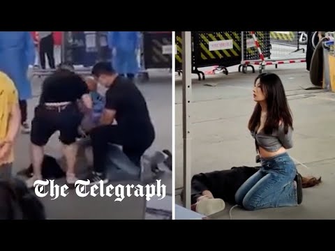 Women pinned to ground and hands tied by Covid security for not wearing mask in China