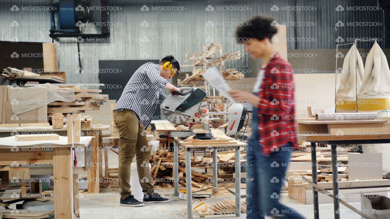 Workshop employee working with circular saw indoors sawing wood - YouTube