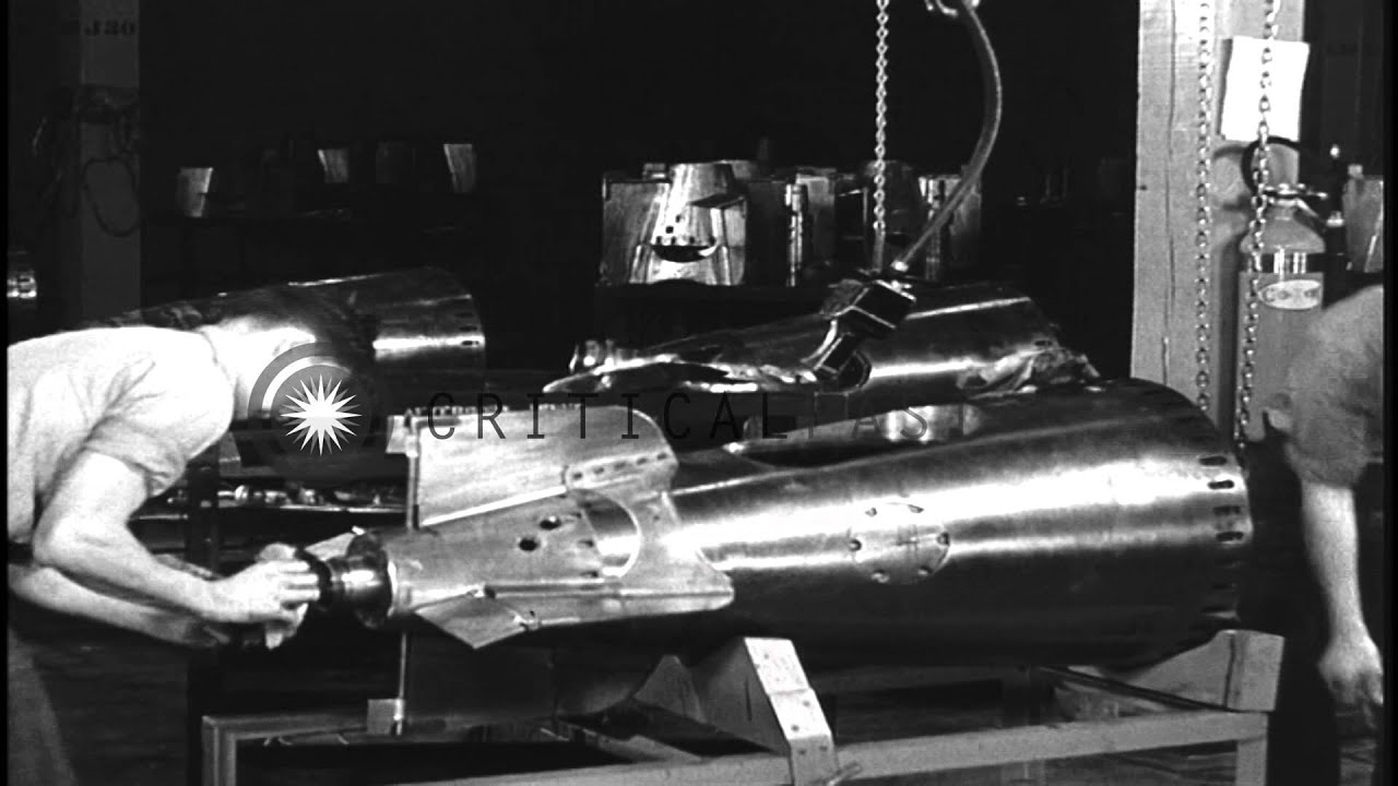 Men working on different part of torpedoes inside a torpedo shop in ...