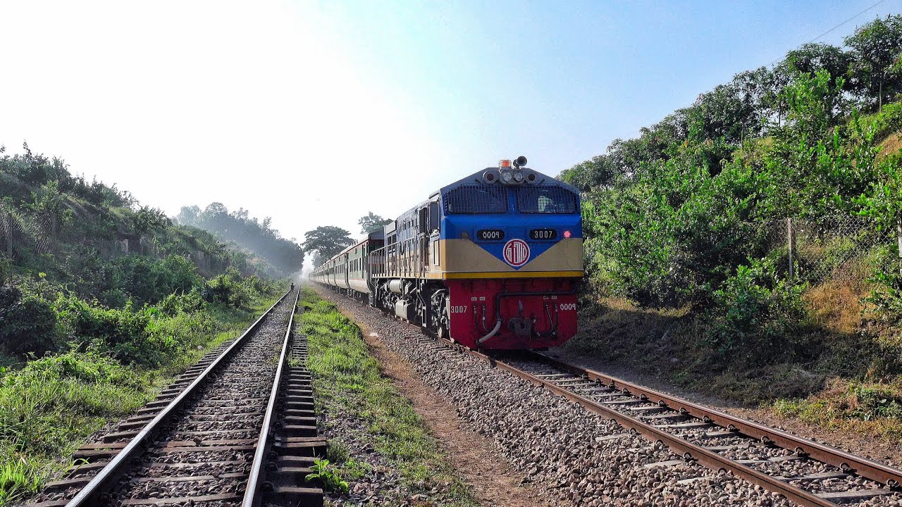 Subarna Express Train going through hills besides Mahamaya Lake ...