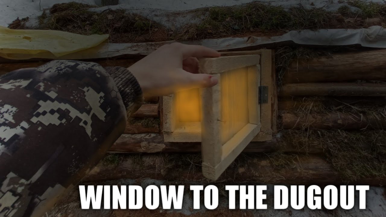 Window to the dugout. Internal work. House underground in a wild forest ...