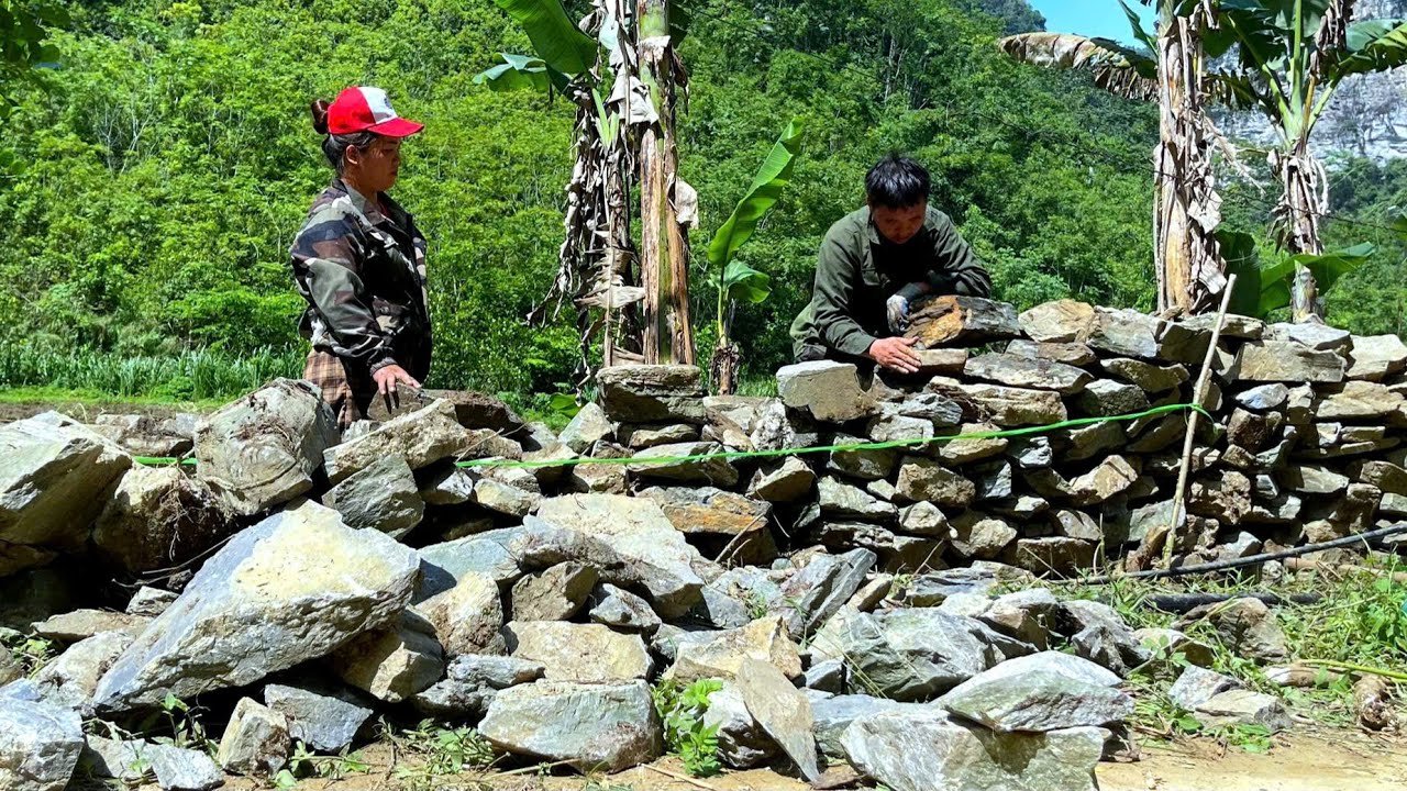 The young couple built the pond bank together with large, sturdy rocks ...
