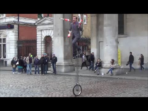 Street Performer Juggling Clubs while Riding a Unicycle. London Covent ...