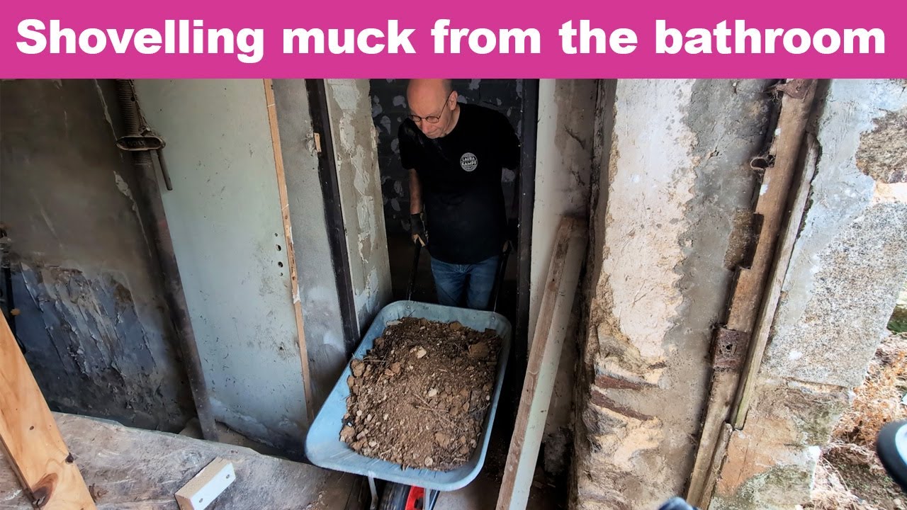 Shovelling muck from the bathroom at the French farm house renovation ...