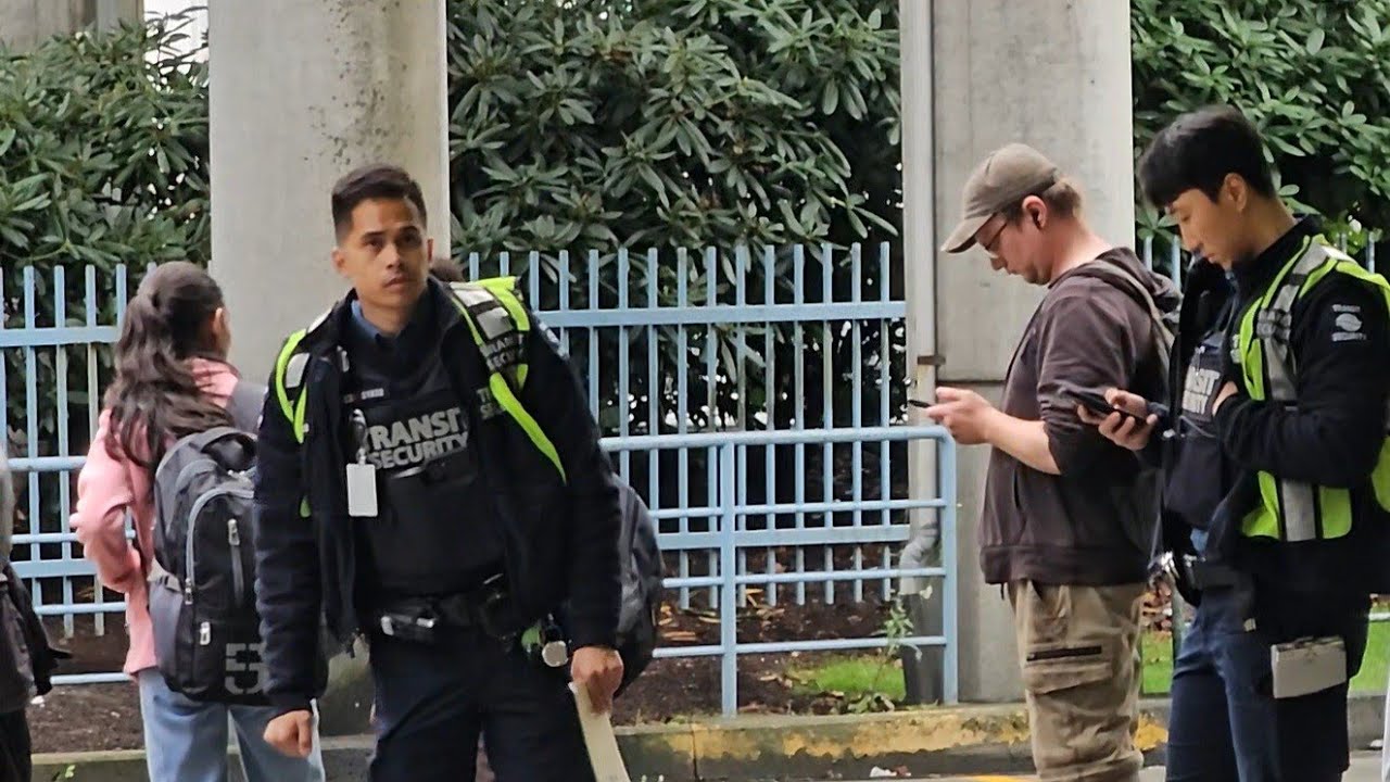 Transit security stand around at SkyTrain station looking for people to ...