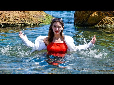 THIS IS SO COOL! A BEAUTIFUL MODEL IN A WARM WET JACKET AND WET JEANS POSES GENTLY FOR WETLOOK VIDEO