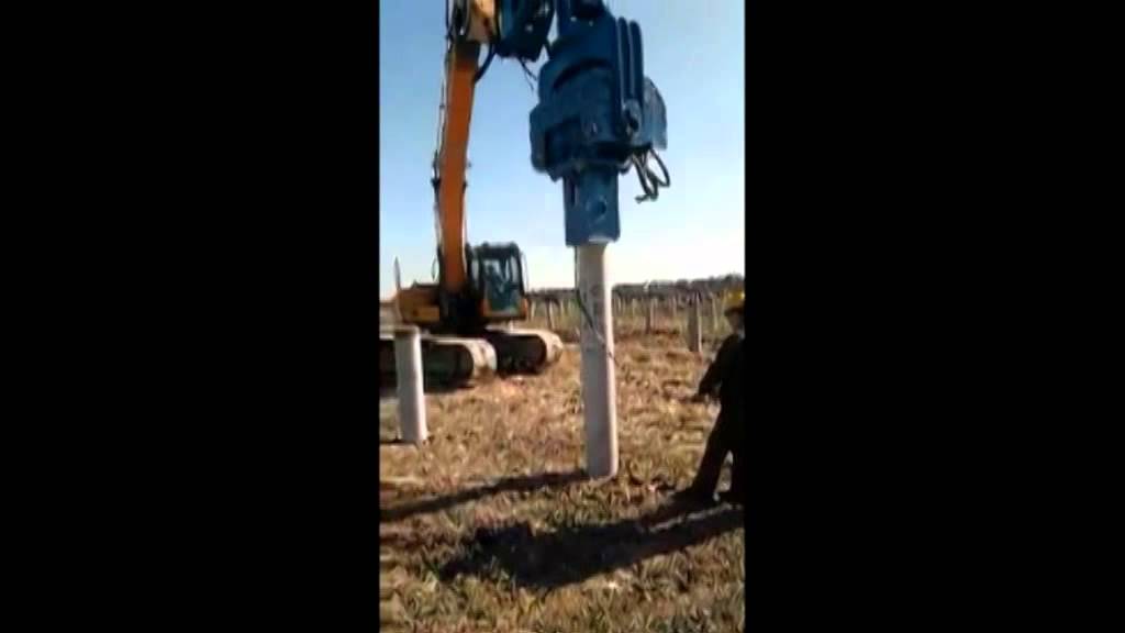 Construction excavator vibratory pile driver for sheet piles - YouTube