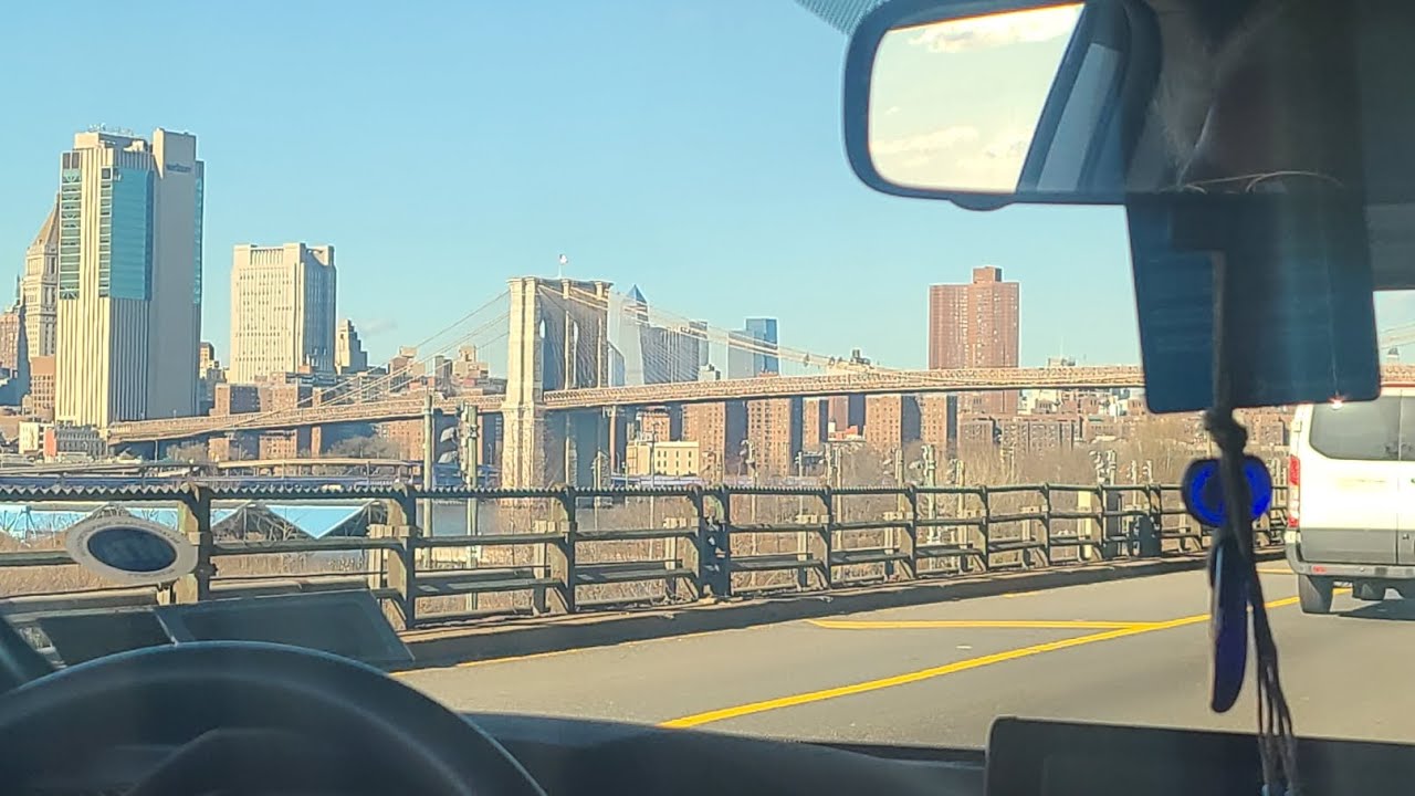 Driving across the Brooklyn Bridge on a beautiful sunny New York day ...