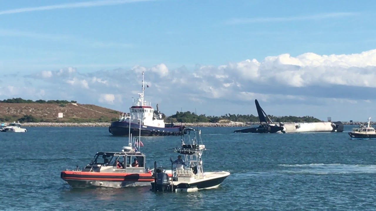 SpaceX Floating Falcon-9 Towed Into Port - YouTube
