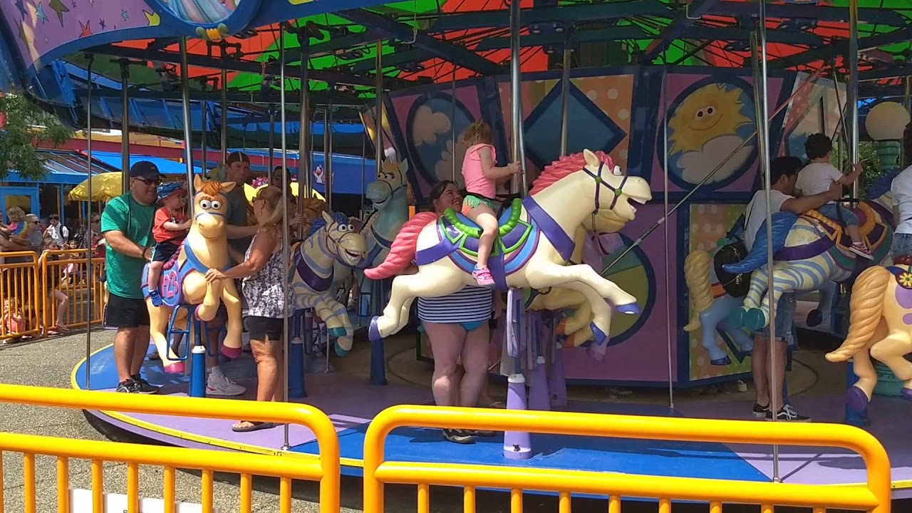 Olivia riding Elmo carousel - YouTube