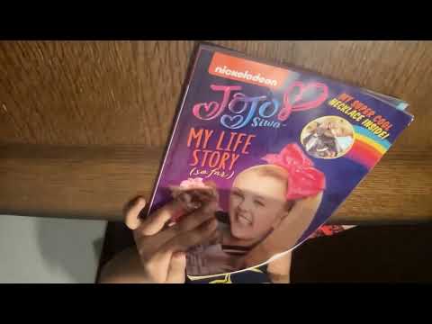 Reading a book named JoJo Siwa My Life Story (so far).