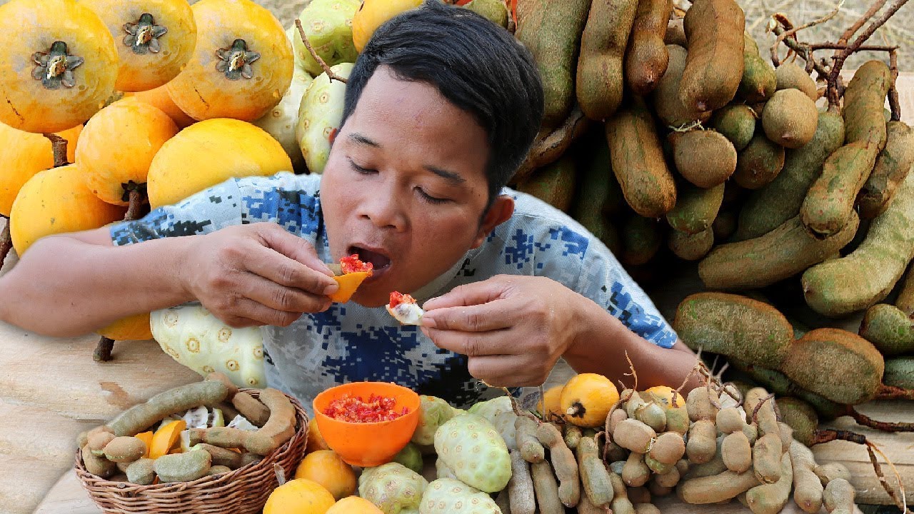Eating tamarind, Noni local fruits Vs hot chili Salt very tasty ...