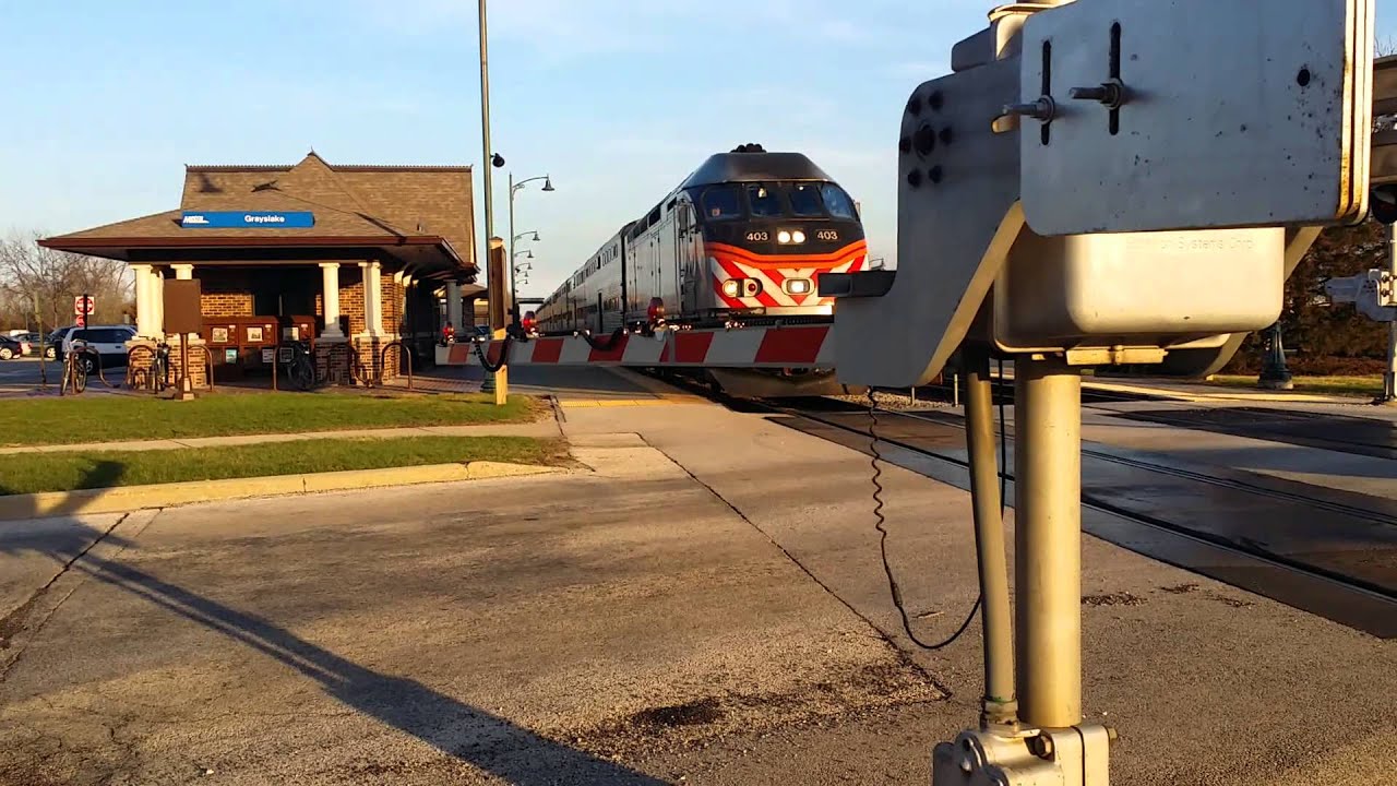 Metra MP36-3S 403 leads an outbound rush hour train into Grayslake on 3 ...