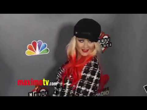 Xtina posing on a red carpet like the rent was due