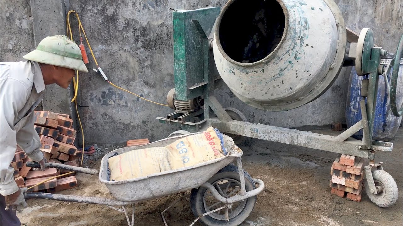How a worker mixes mortar to build a wall with a mini mixer - YouTube