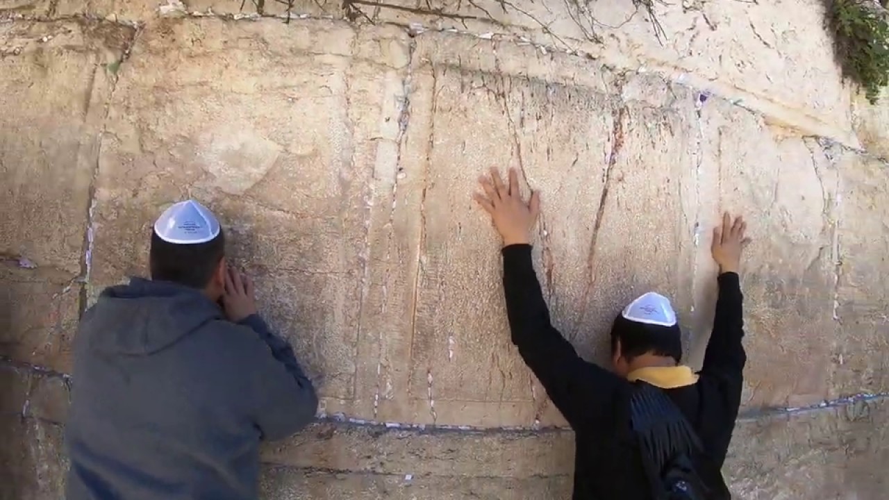 Touching the stones of the Western Wall - YouTube
