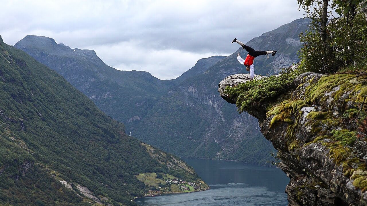 One Hand Balance On A Cliff In Geirangerfjord - YouTube