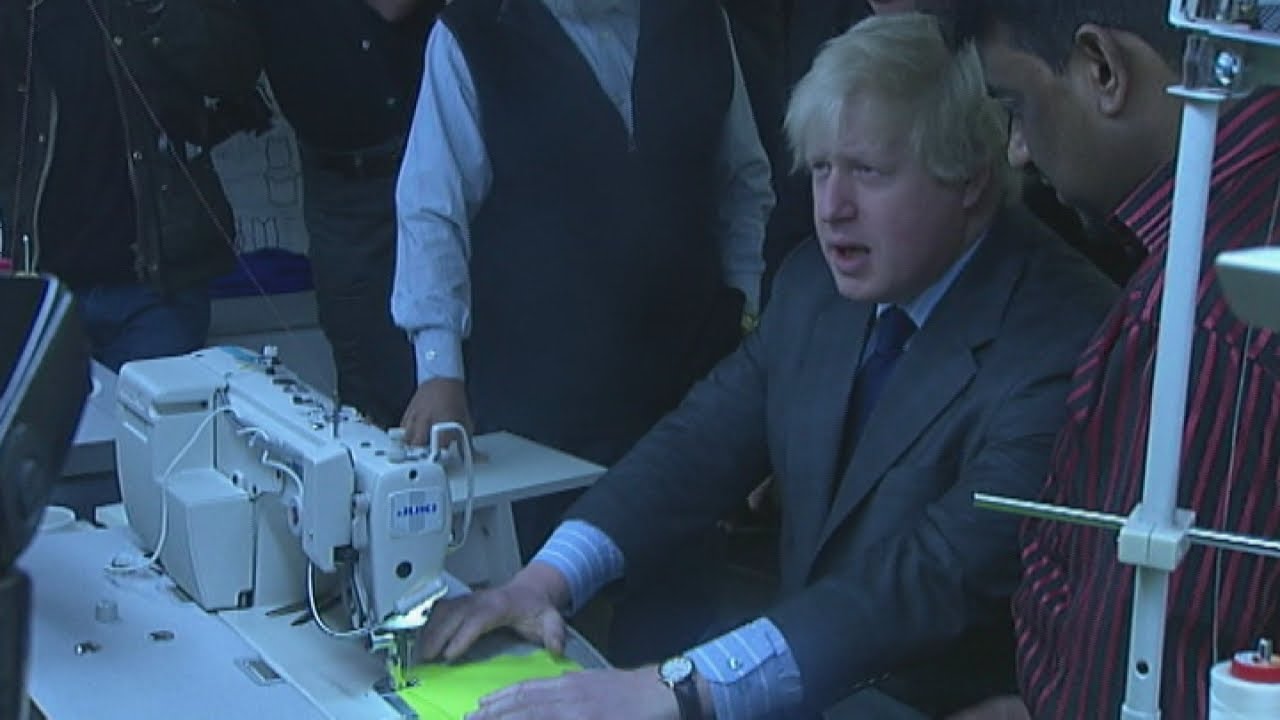 Boris Johnson tries sewing a 'codpiece' at a London clothing factory ...