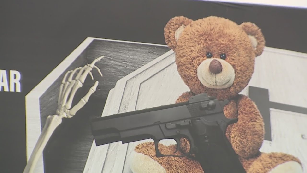 Why a teddy bear, gun and casket are on this billboard - YouTube