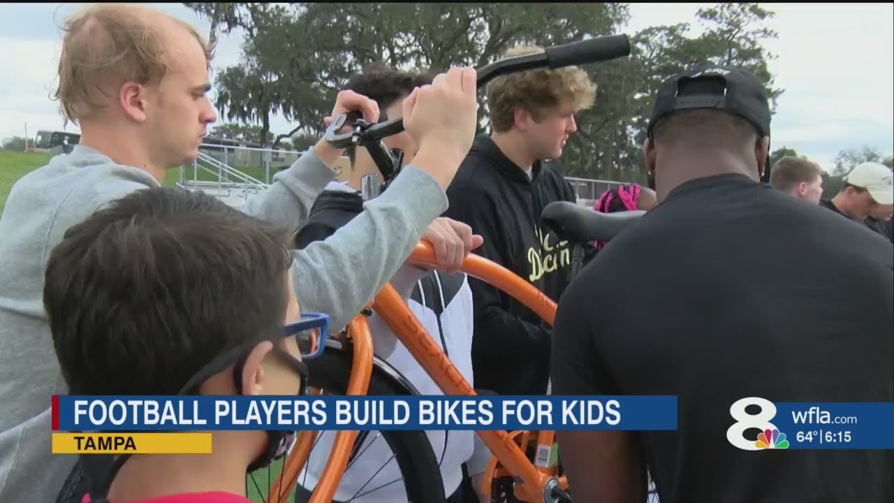Football players build bikes for local kids - YouTube