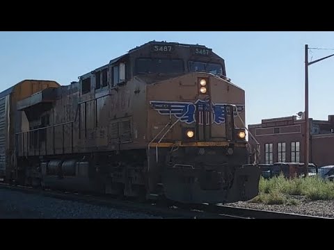 UP C45ACCTE 5487 solo leads a autorack train onto a siding to let ...