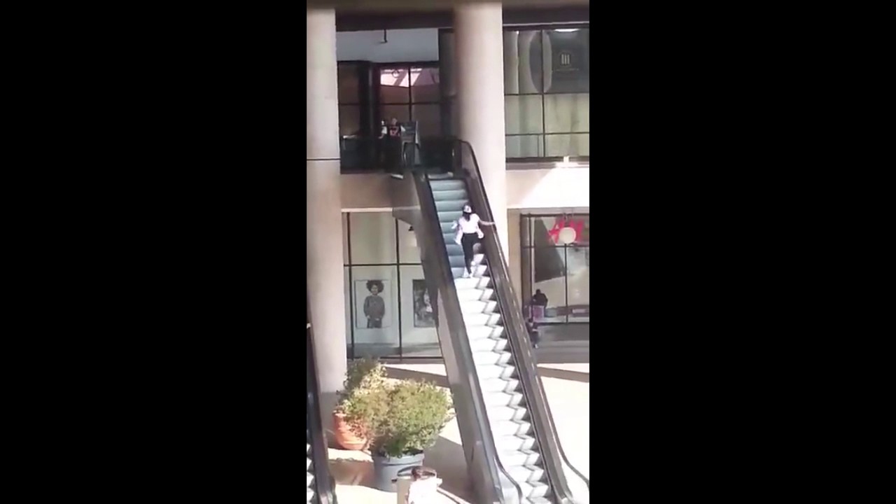 Fail: girl walks up escalator the wrong way - YouTube