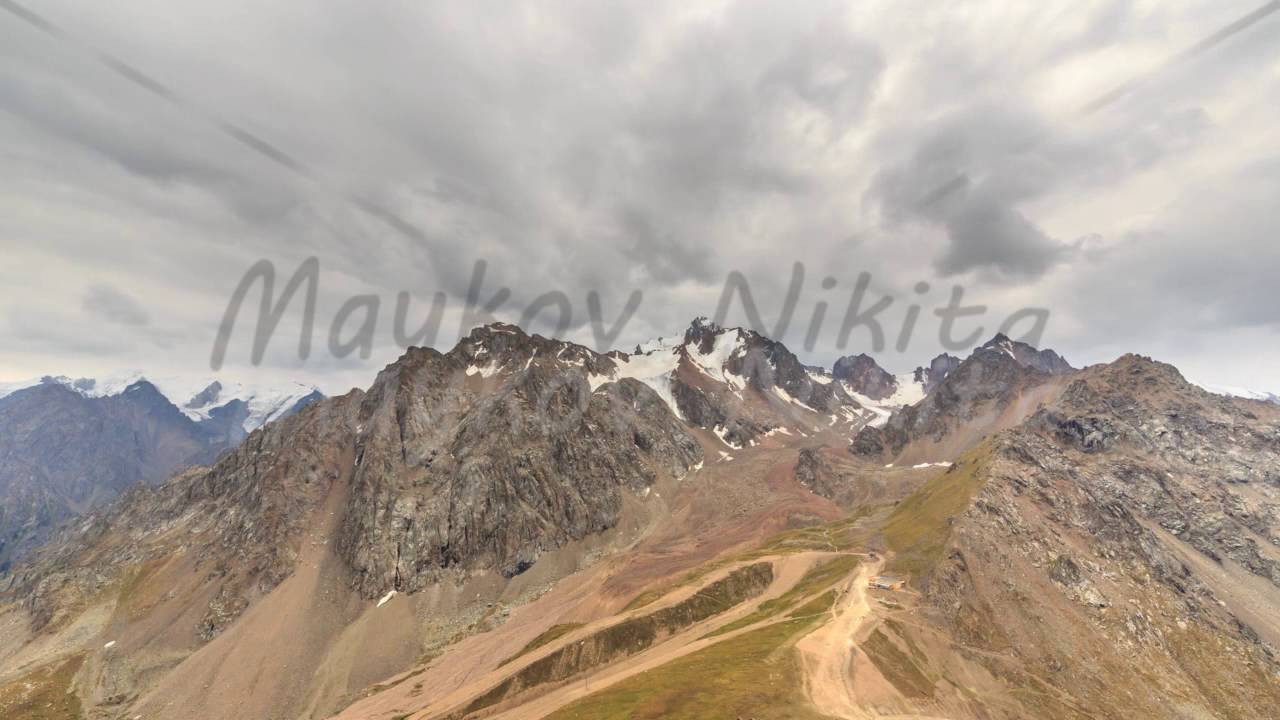 Clouds over snowy peaks. Talgar Pass, Chimbulak. Almaty. Kazakhstan. 4K ...