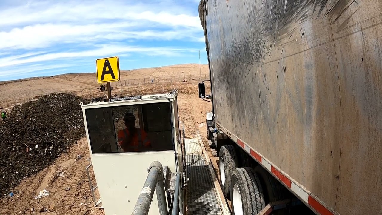 Backing onto the landfill tipper, tipper view. - YouTube