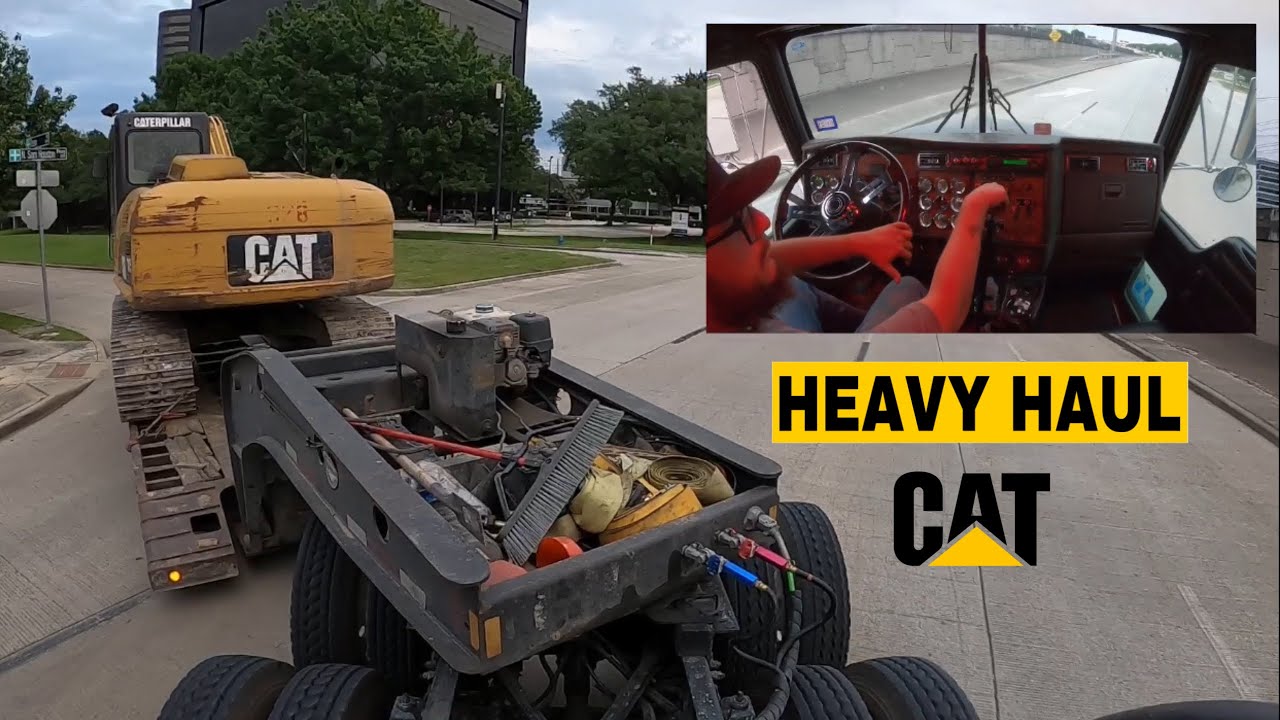Heavy haul trucker | RGN lowboy moving CAT excavator through downtown ...