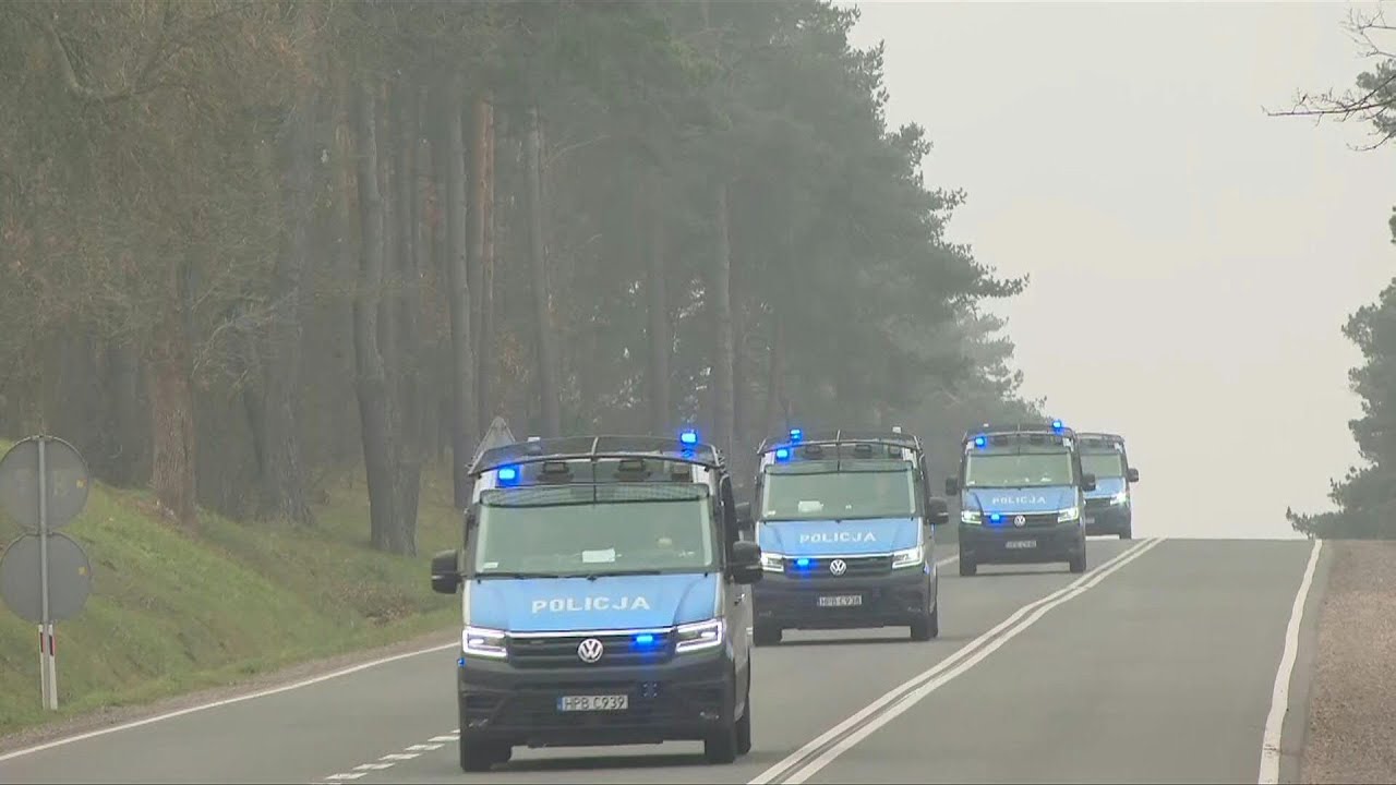 Police vans at checkpoint of entrance to emergency zone near Polish ...