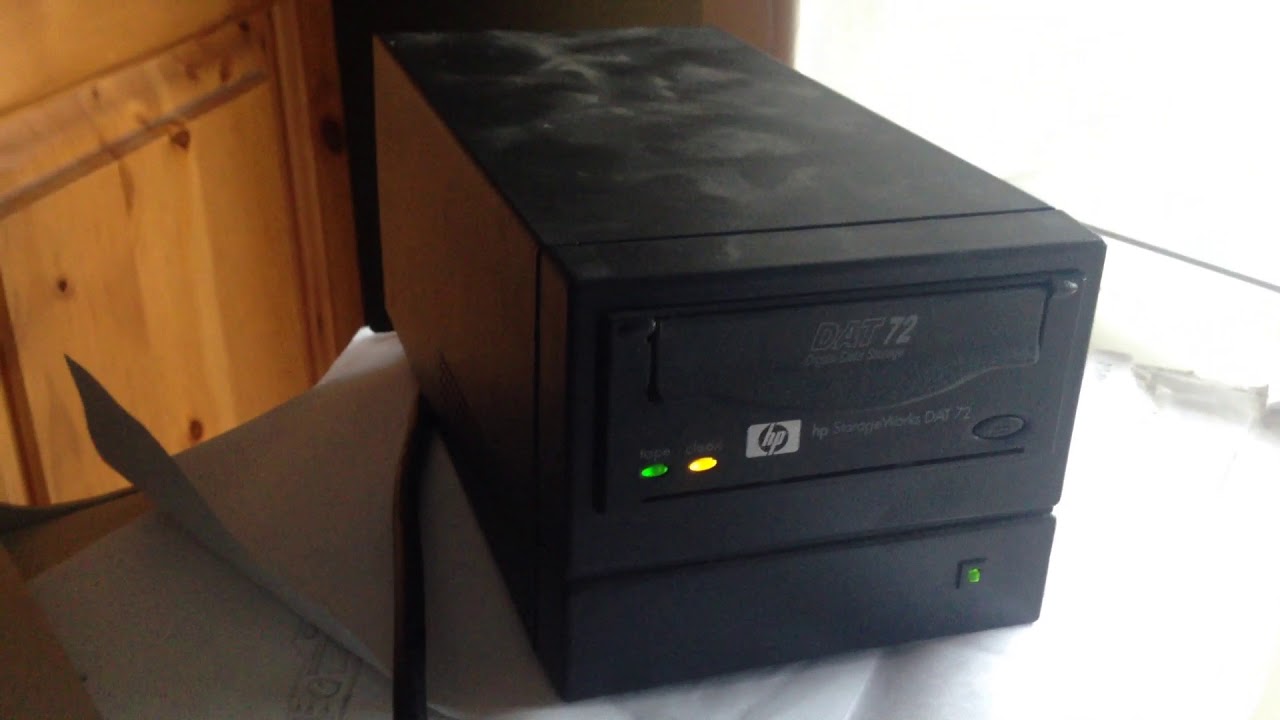 Putting a tape in a tape backup thing - YouTube