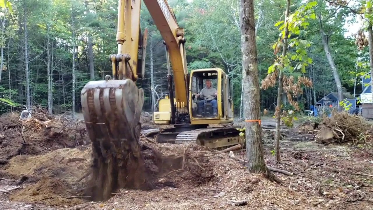 Pulling stumps with an excavator on the homestead. - YouTube