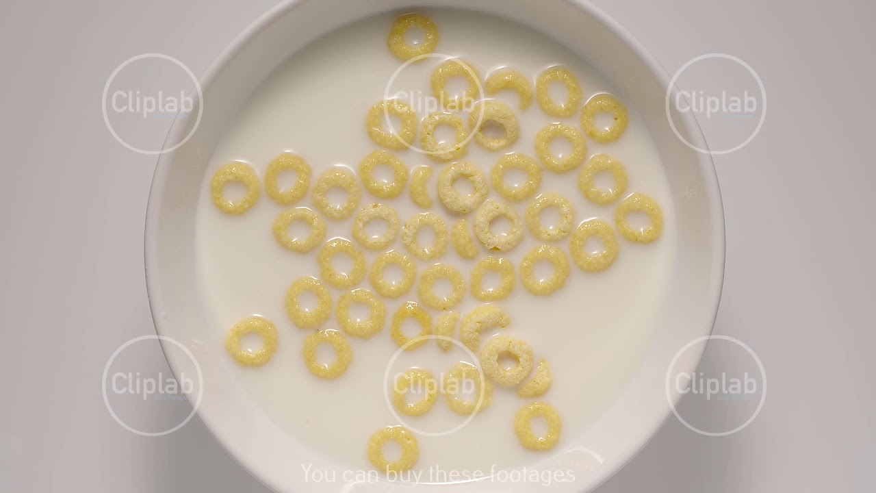 TOP VIEW: Breakfast ring cornflakes and milk in a white bowl on the ...