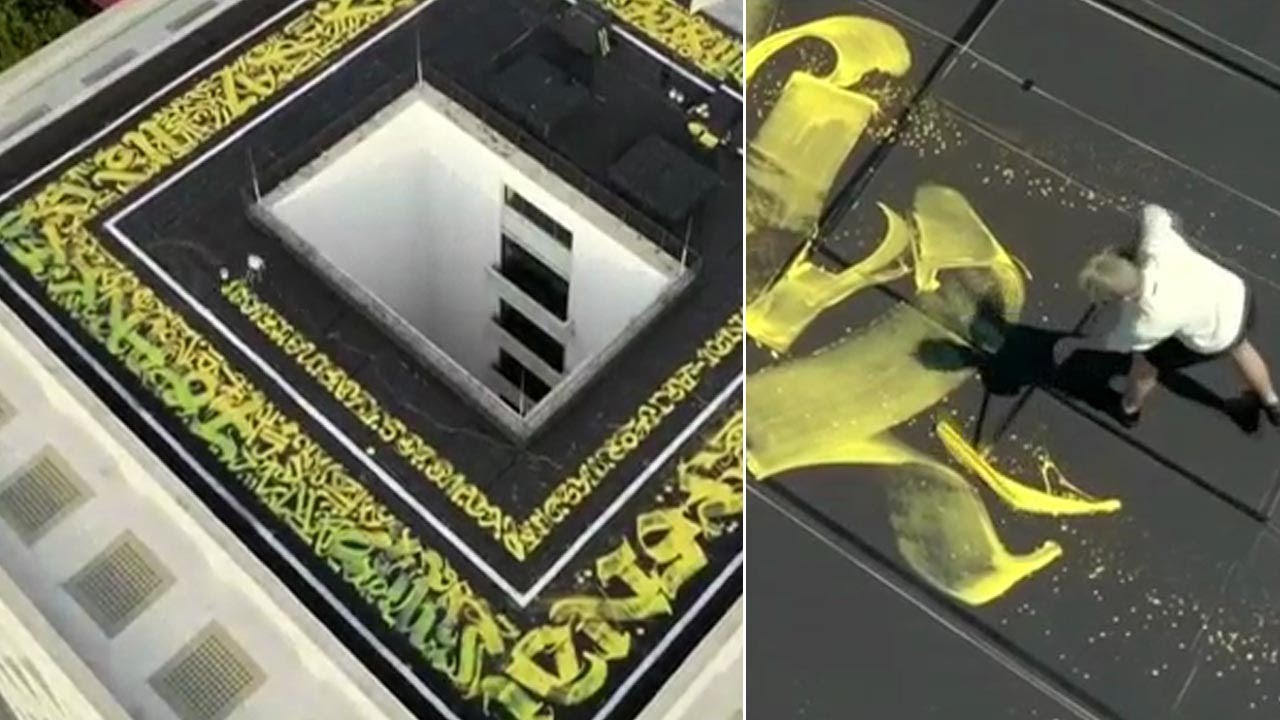 Artist covers Rome rooftop with massive calligraphy artwork - YouTube