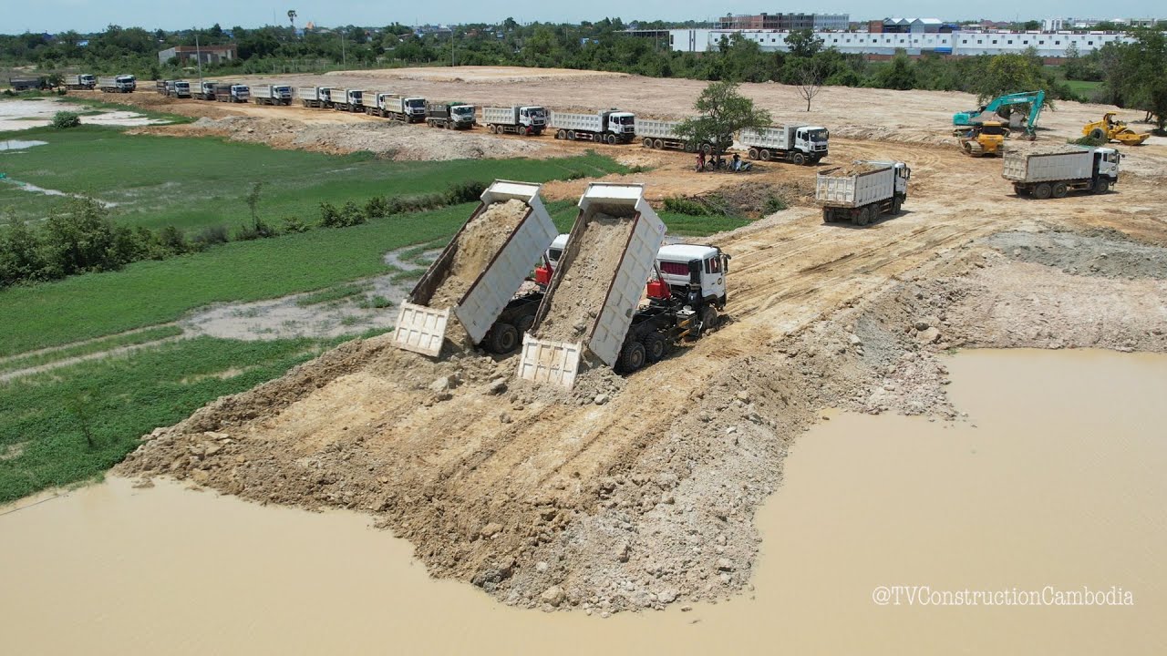 Huge Land Filling Up Process Lots Of Dump Trucks Are Dumping Soil And ...