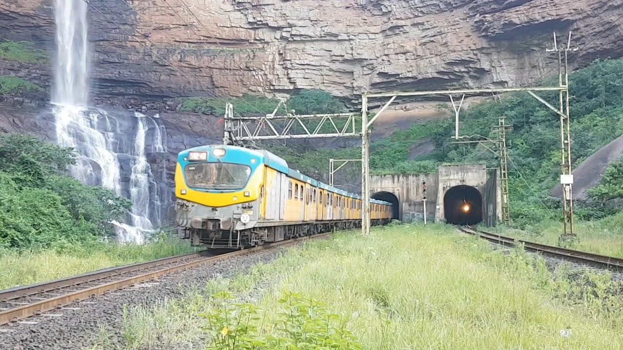 Metro 10m5 passenger train passing Spoornet class 18E locomotives at ...