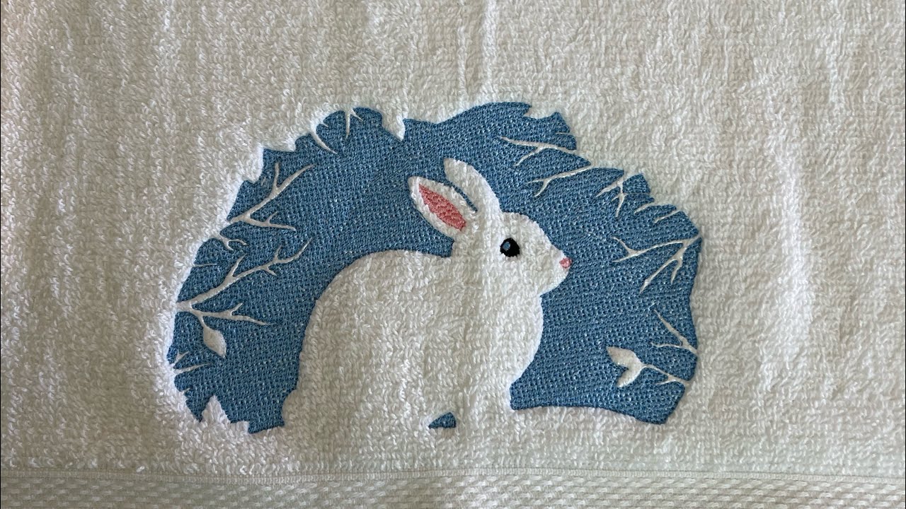 Machine embroidering onto a towel with a design from Embroidery Library ...