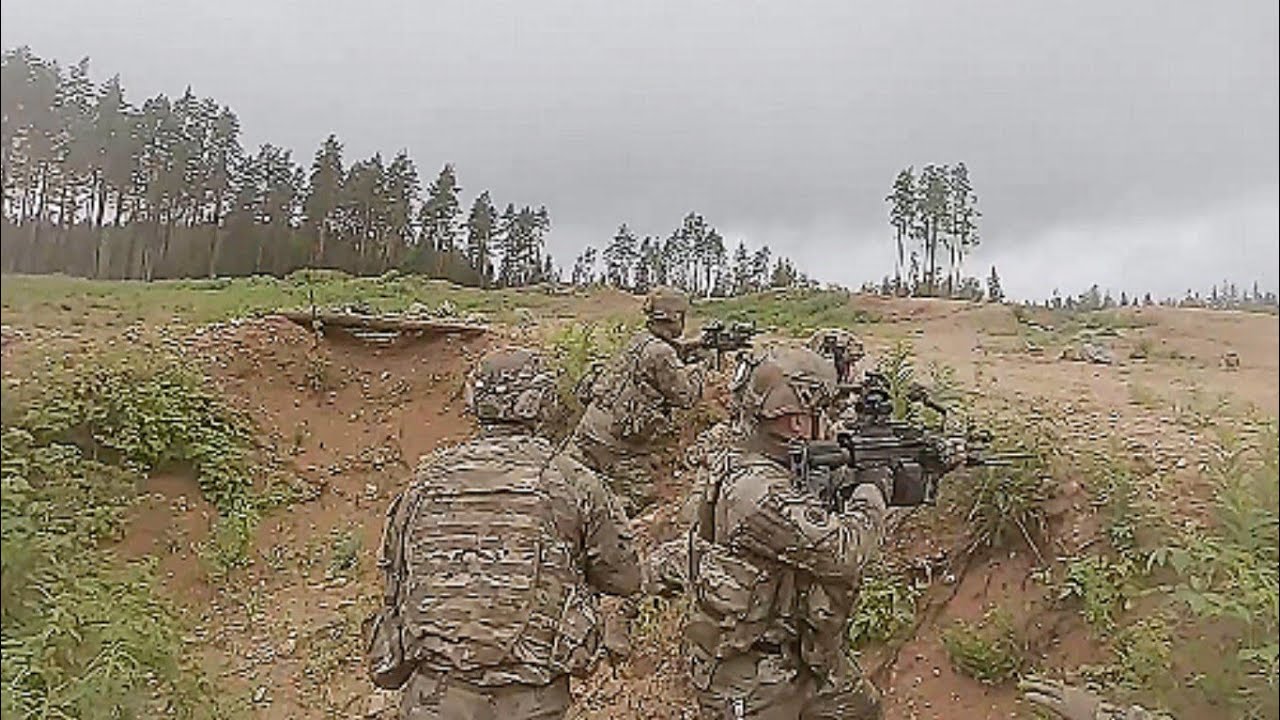 large-scale war simulation of American soldiers storming trenches in ...
