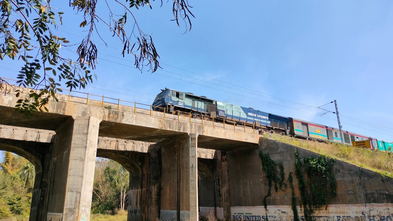 Blue-grey livery WDP4B led Palace Queen Humsafar crosses the Arkavathi ...