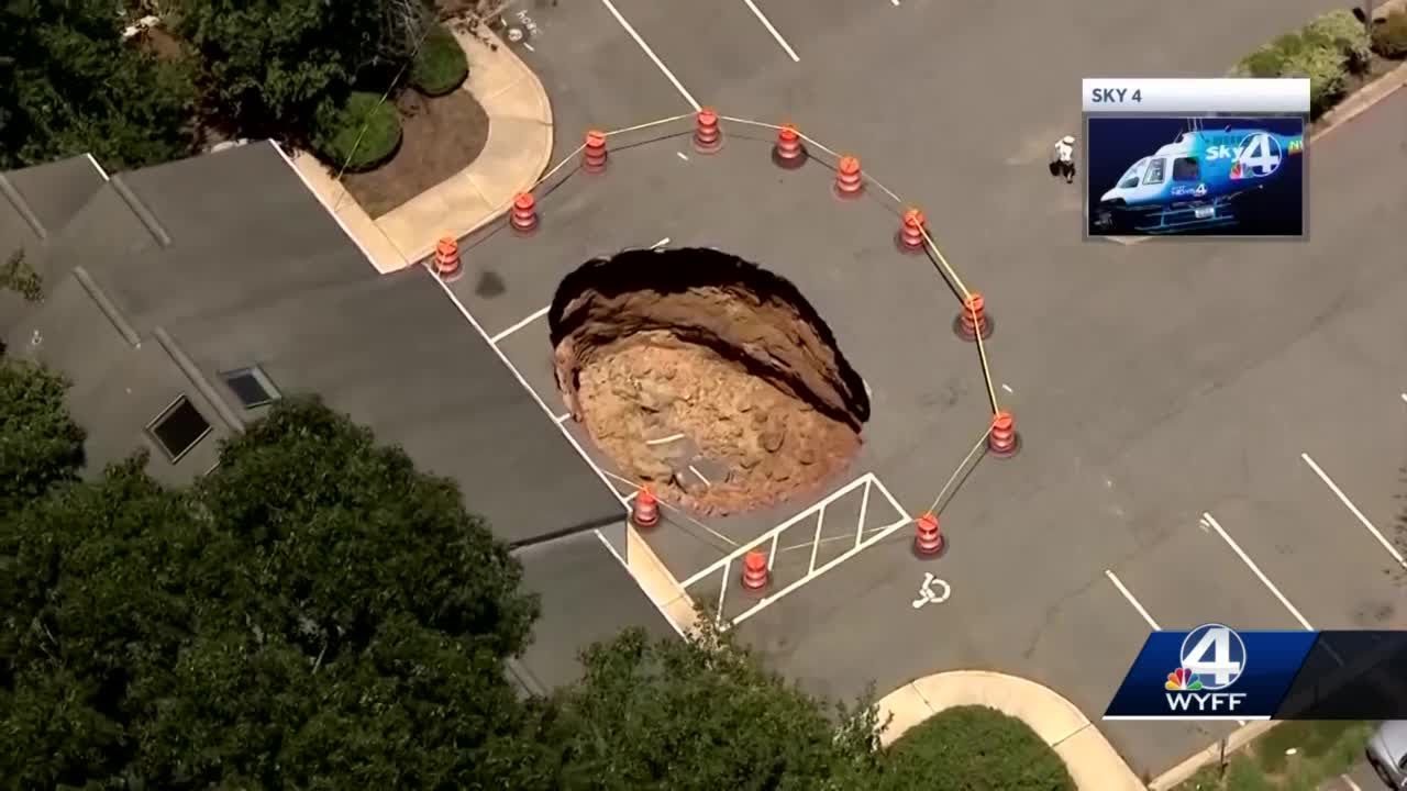 Second sinkhole opens up near original one on busy Asheville road - YouTube