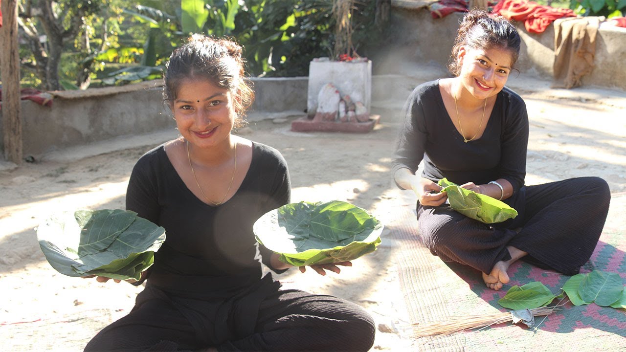 village girl and her mother making plates(tapari) of leaves in ...